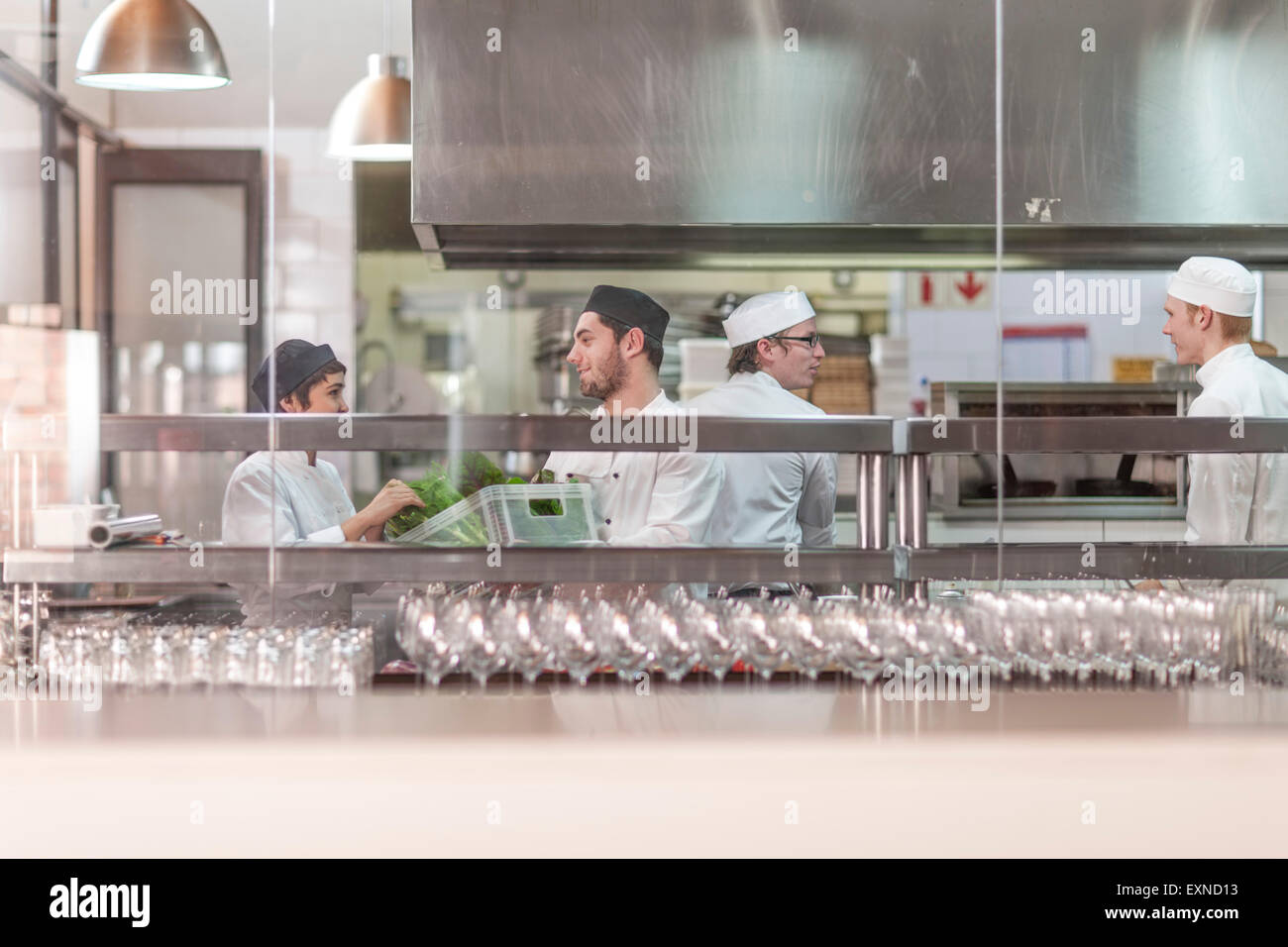 Chefs working in restaurant kitchen Stock Photo - Alamy