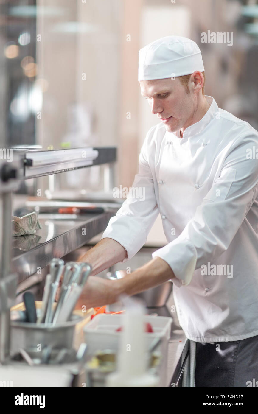 Chef preparing food in restaurant kitchen Stock Photo - Alamy
