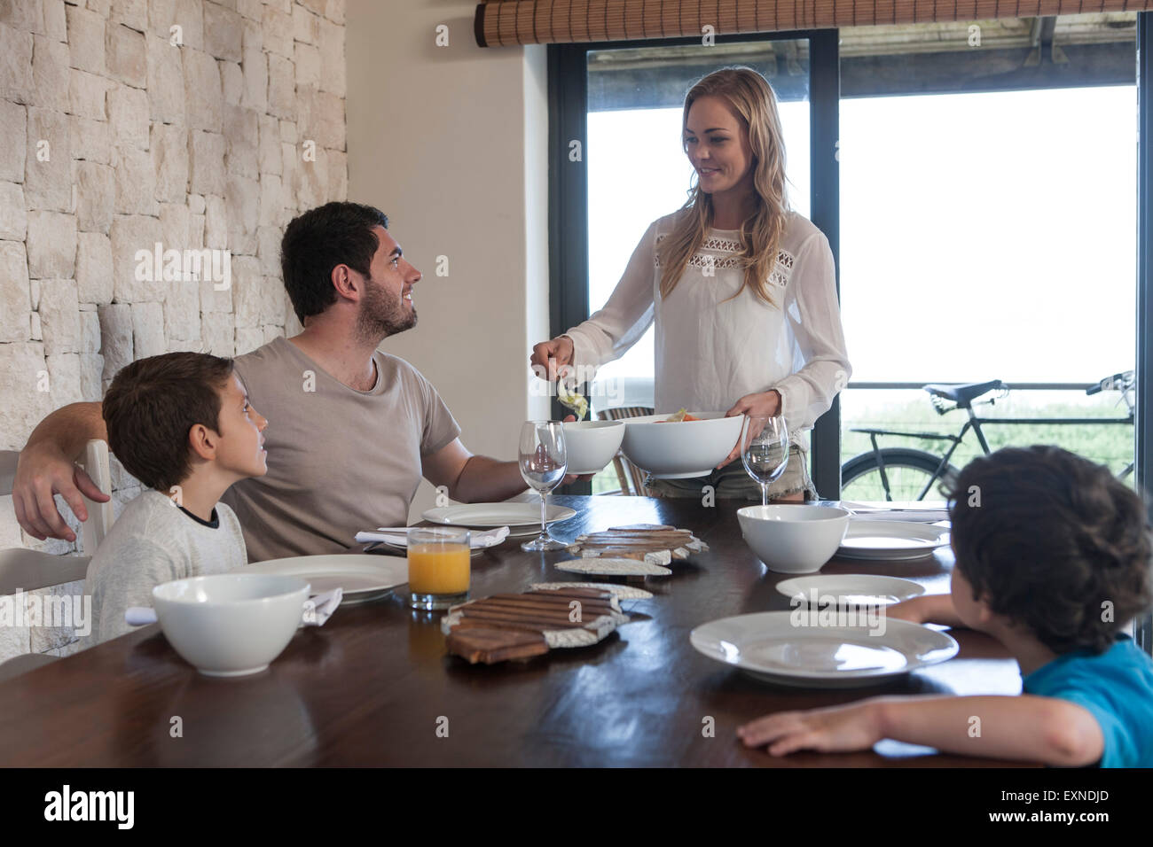 Family having lunch at dining room table Stock Photo - Alamy