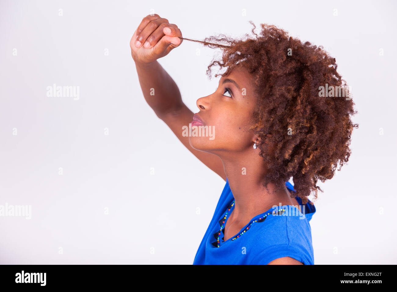 Young African American woman holding her frizzy afro hair - Black ...