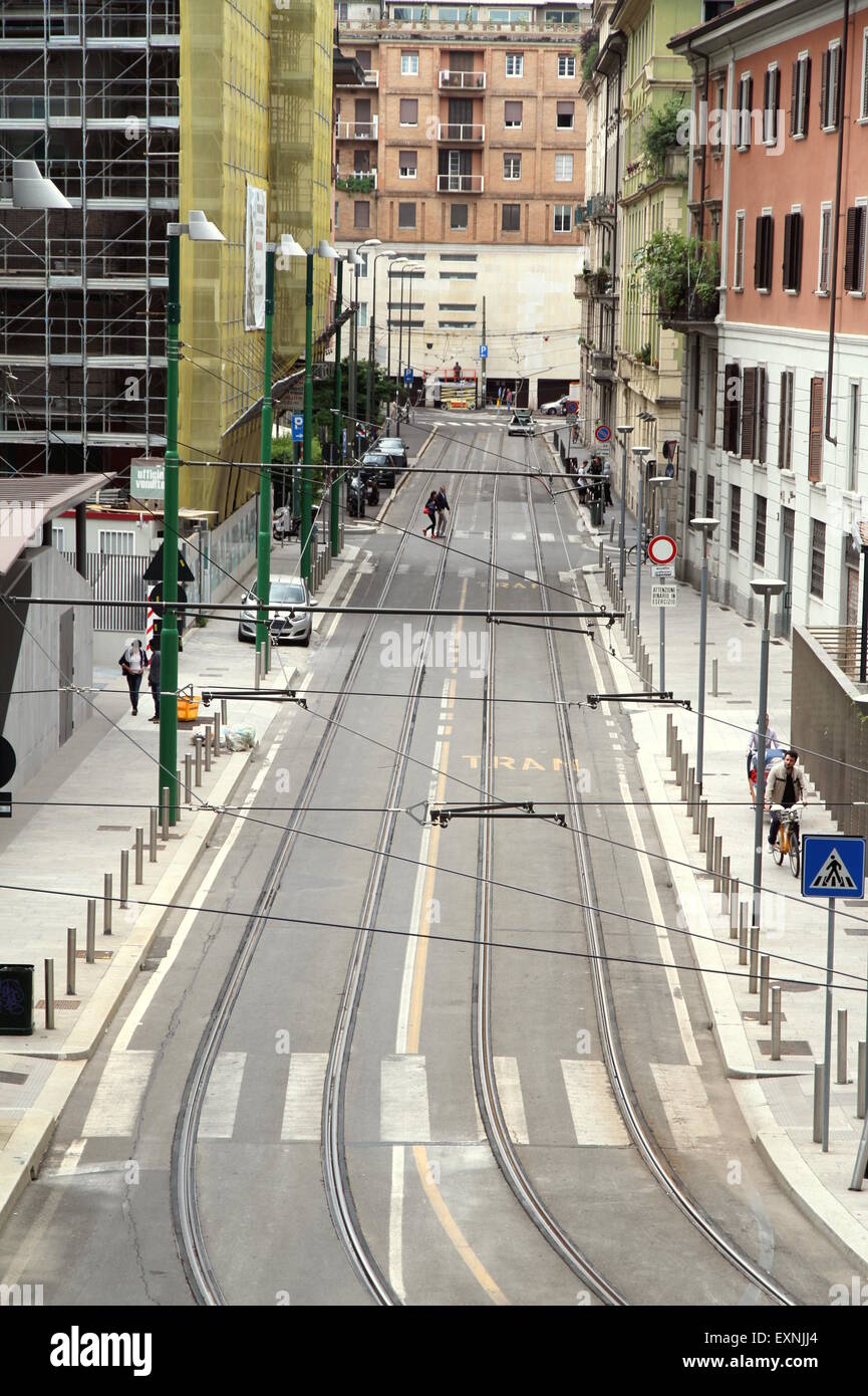 Streetcar tracks and cables in a deserted street of Milan, Italy Stock ...