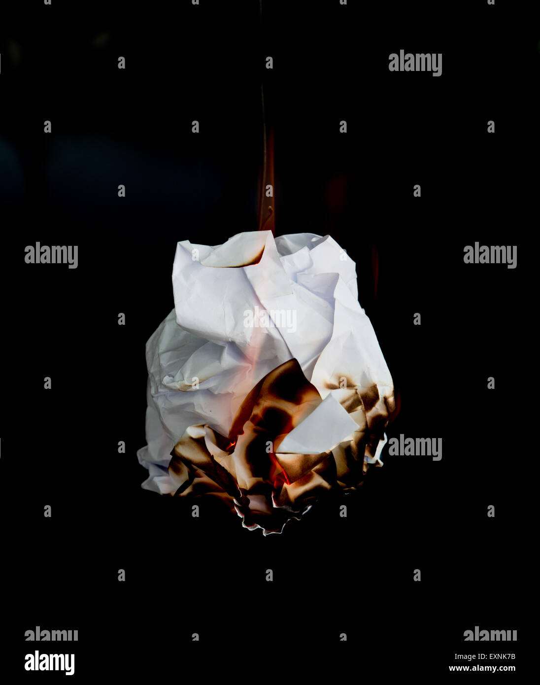 white crumpled paper burning on black background Stock Photo - Alamy