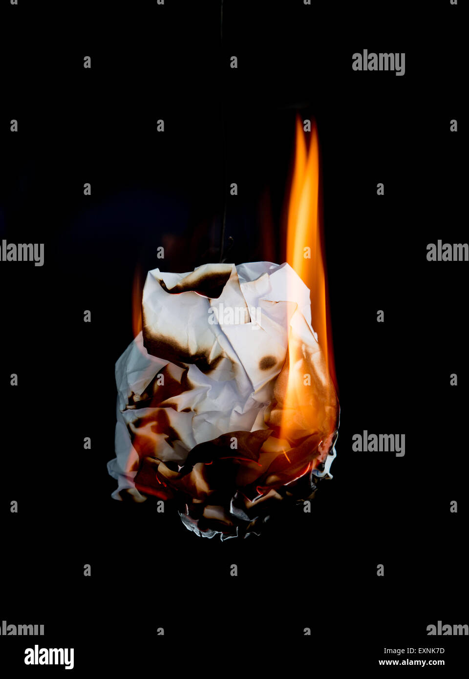 white crumpled paper burning on black background Stock Photo - Alamy
