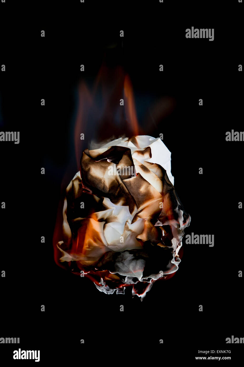white crumpled paper burning on black background Stock Photo - Alamy