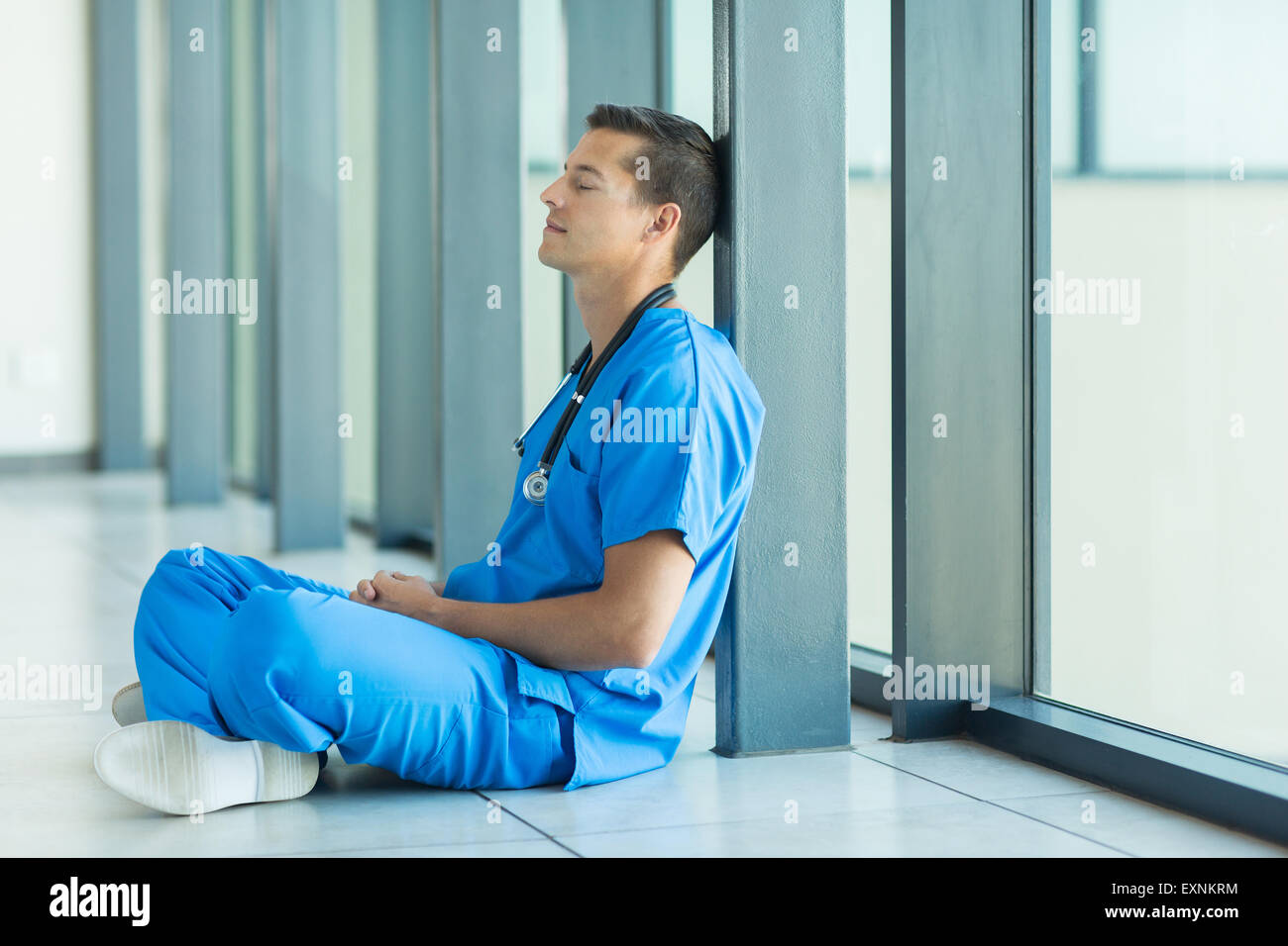 peaceful male doctor relaxing on hospital floor Stock Photo - Alamy