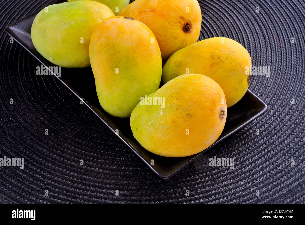 Mango in Black Dish Stock Photo - Alamy