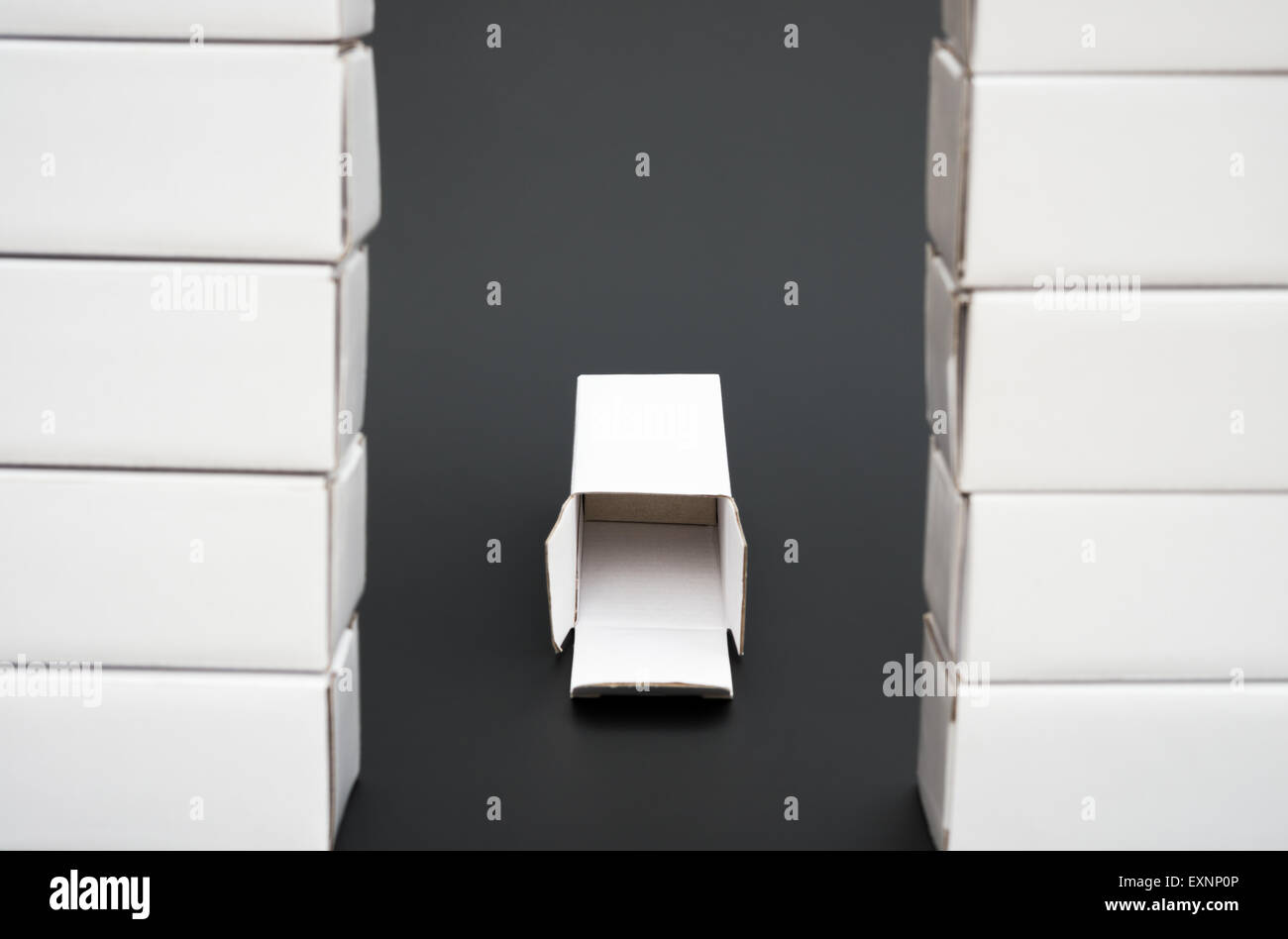two stacks of boxes with one open in the center Stock Photo - Alamy