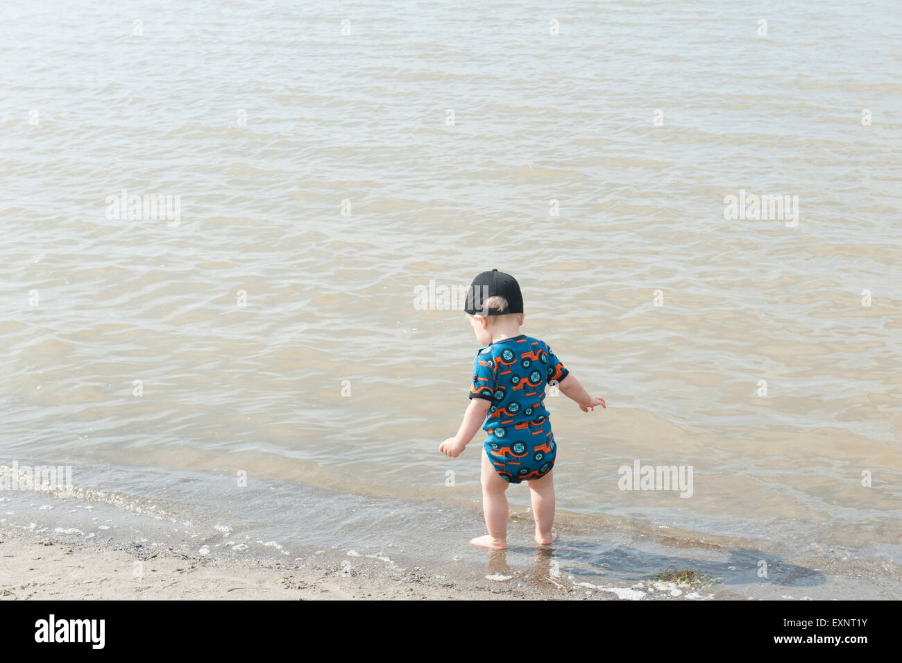 Child wading into water hi-res stock photography and images - Alamy