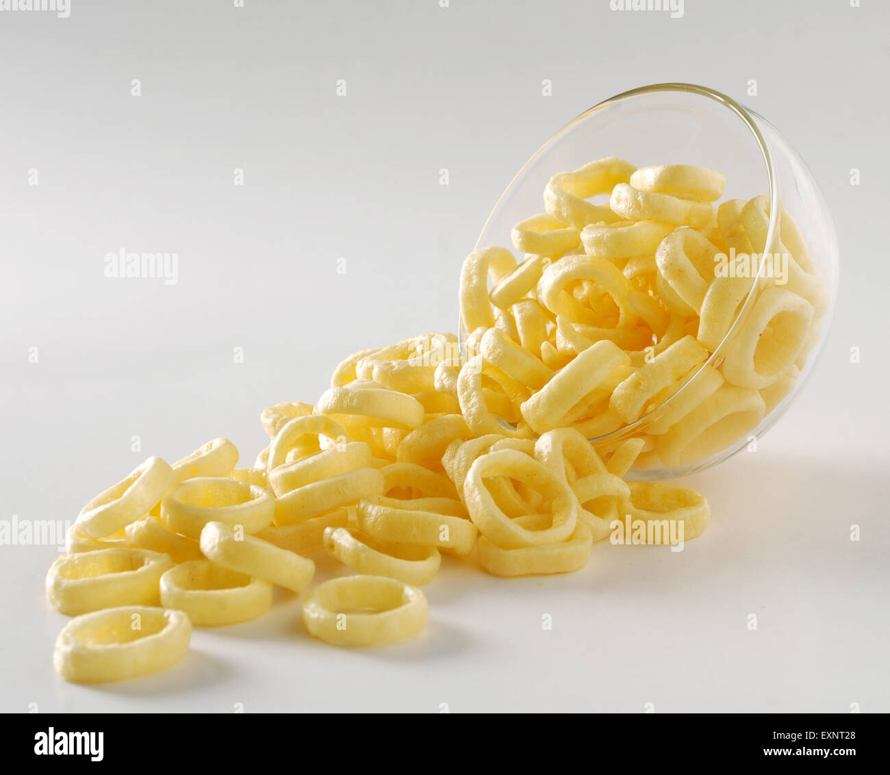 Corn Ring Snacks falling from the crystal bowl Stock Photo - Alamy