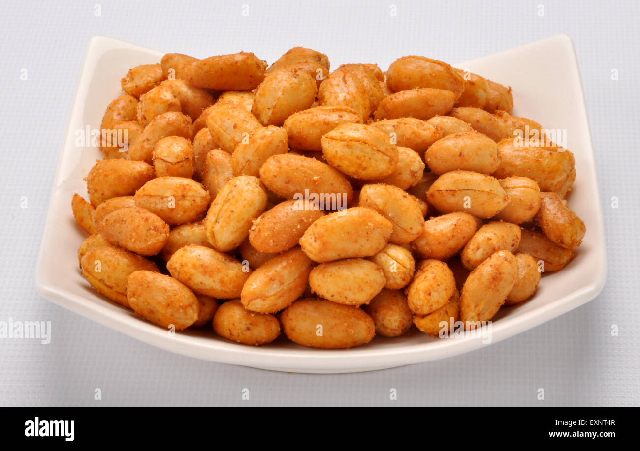 Spicy Peanuts in white dish Stock Photo - Alamy