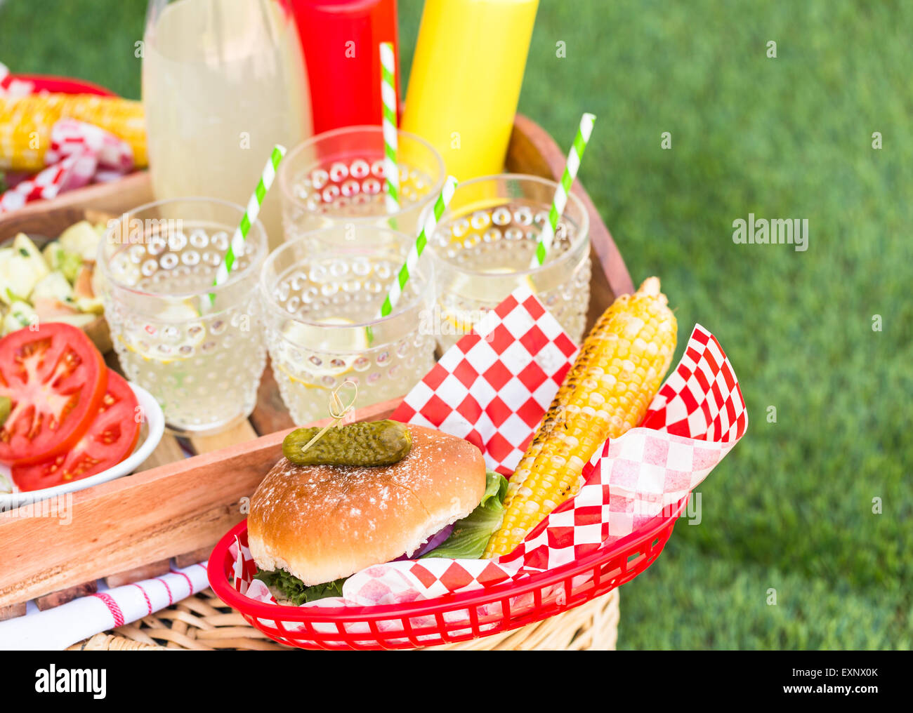 Small summer picnic with lemonade and hamburgers in the park Stock ...
