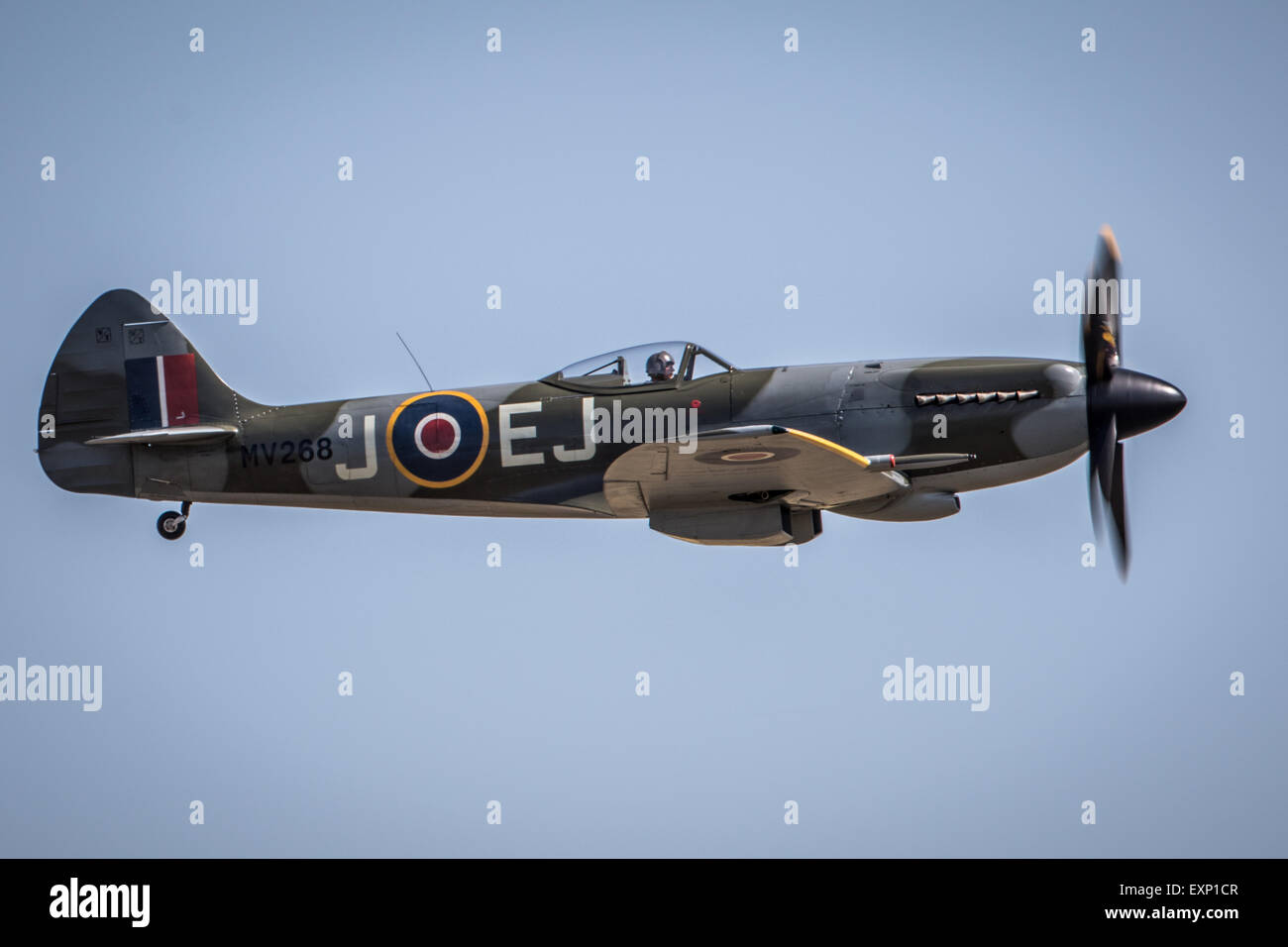 Single Spitfire flying against a blue sky, iconic image of the Battle ...