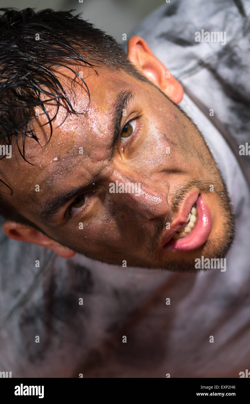 closeup hispanic man with dirty face and shirt lying on floor looking ...