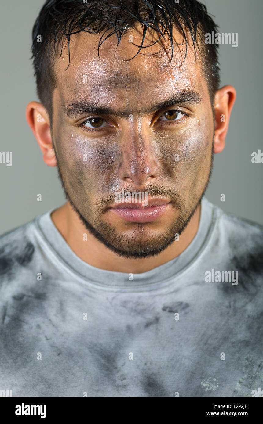 Hispanic man with dirty face and shirt looking to camera serious facial ...