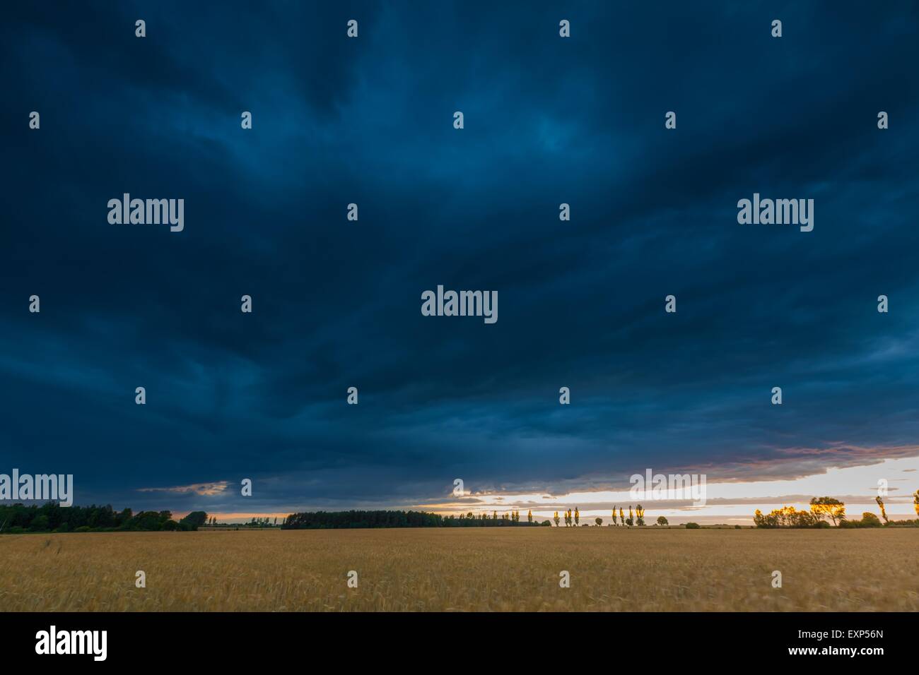 Landscape with dark stormy sky over fields. Beautiful rural countryside ...