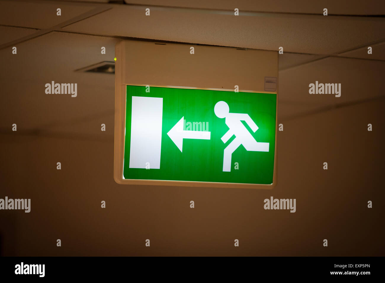 Emergency Exit Sign with Yellow Background Stock Photo - Alamy