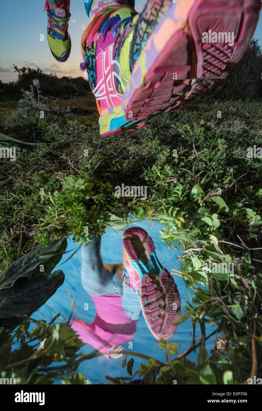 Runner jumping over water Stock Photo - Alamy