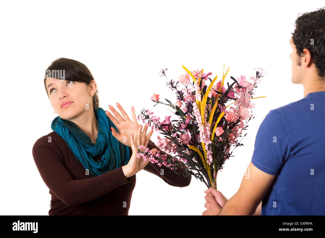 Hispanic couple fighting as man tries to give girlfriend flowers while ...