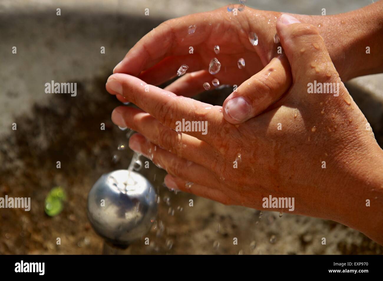 Woman's hands with cold drink water splash Stock Photo - Alamy