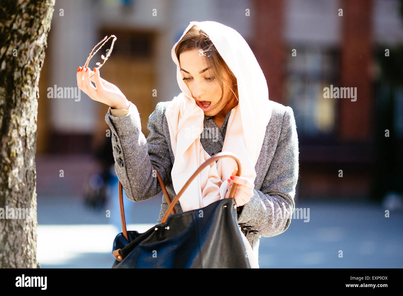 girl looking for something in a bag Stock Photo - Alamy