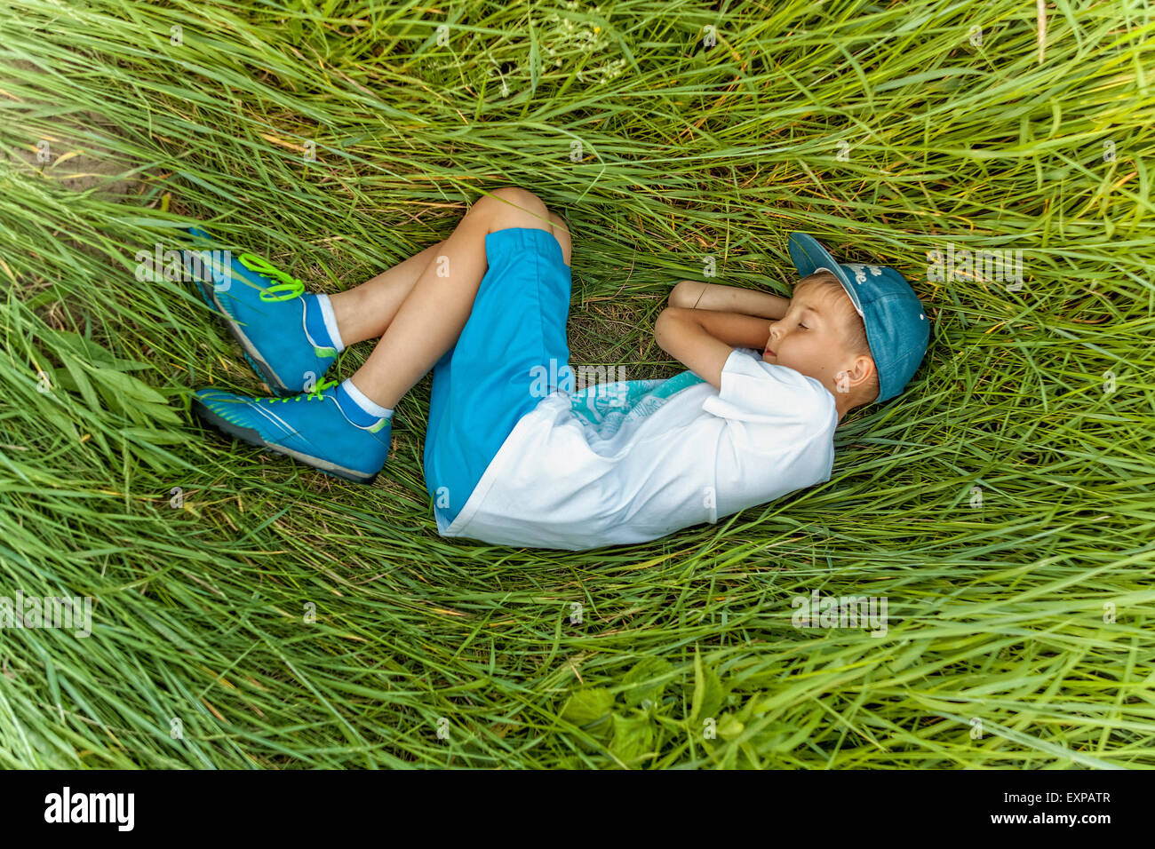 Young boy sleeping in the grass, Poland Stock Photo - Alamy