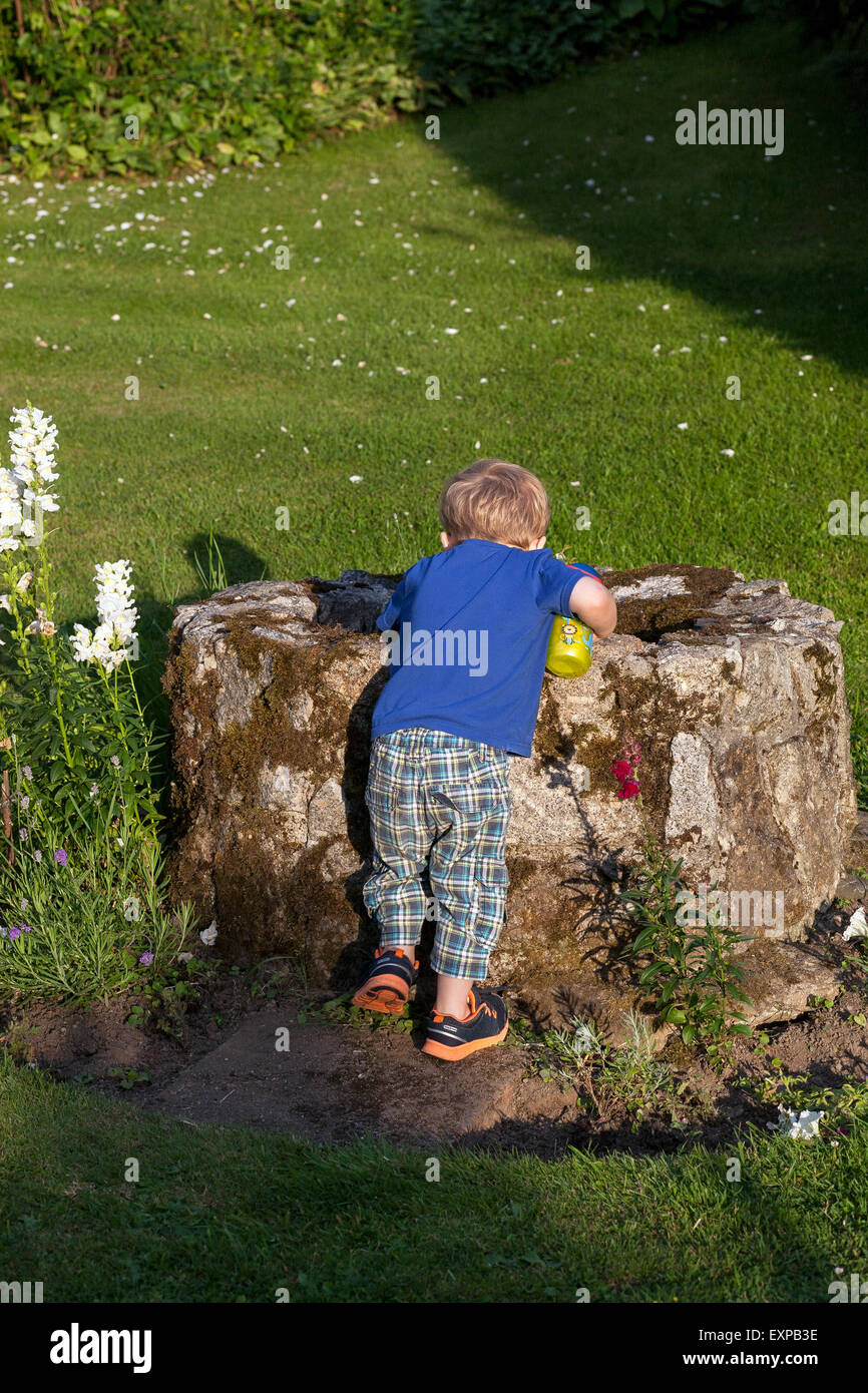 child looking into well,wishing well,danger,health and safety,awareness ...