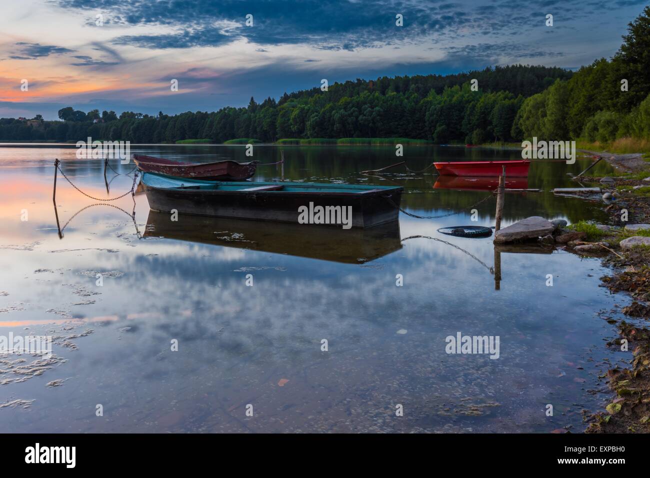 Beautiful lake sunset with fisherman boats. Polish lake in Mazury lake ...