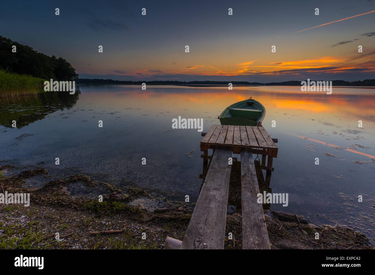 Beautiful lake sunset with fisherman boats. Polish lake in Mazury lake ...