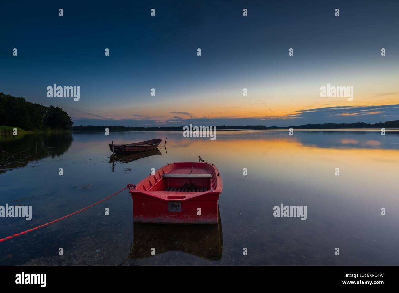 Beautiful lake sunset with fisherman boats. Polish lake in Mazury lake ...