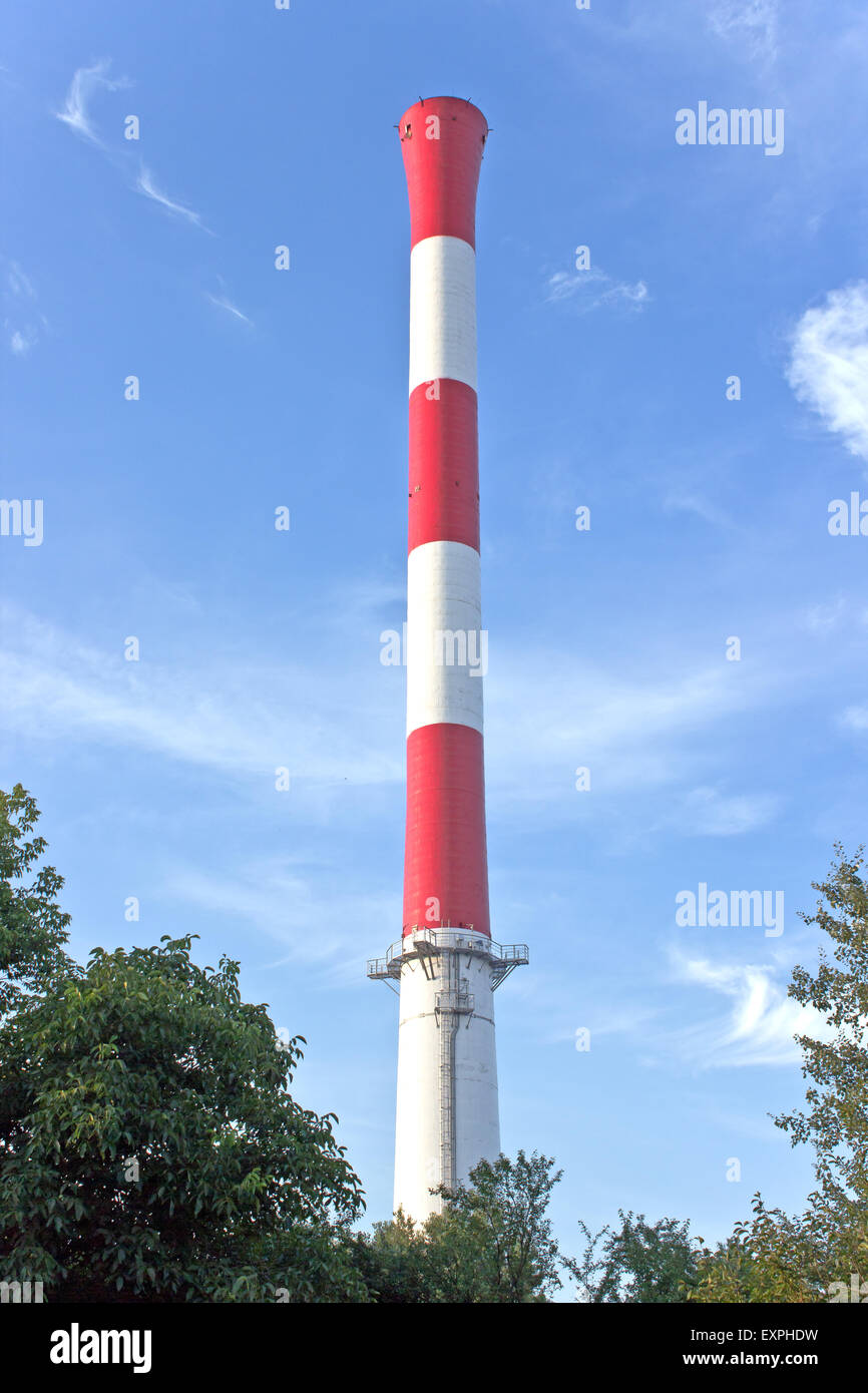 Industrial red and white chimney over blue sky Stock Photo - Alamy