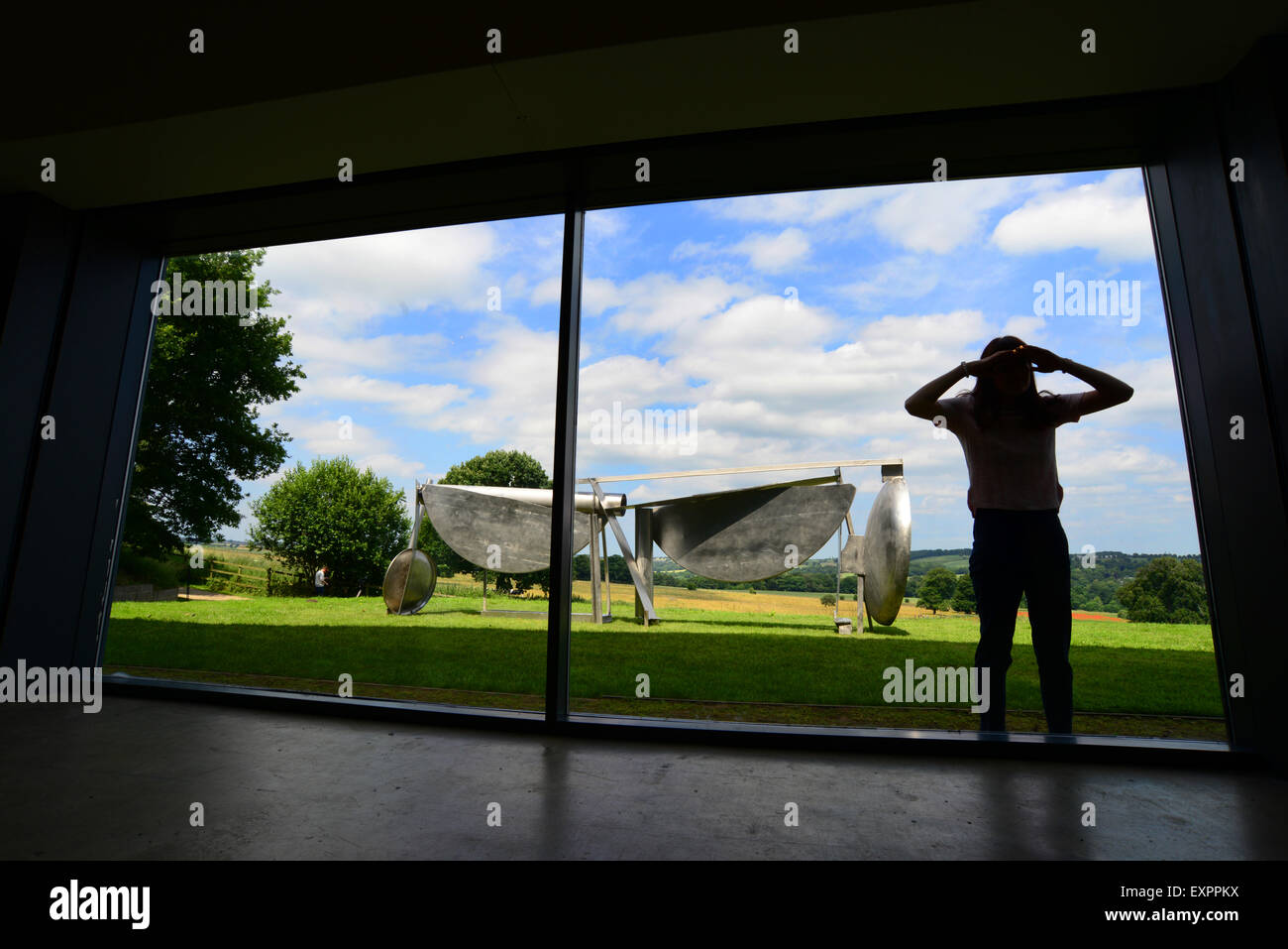 A Yorkshire Sculpture Park visitor looks through a window to see ...