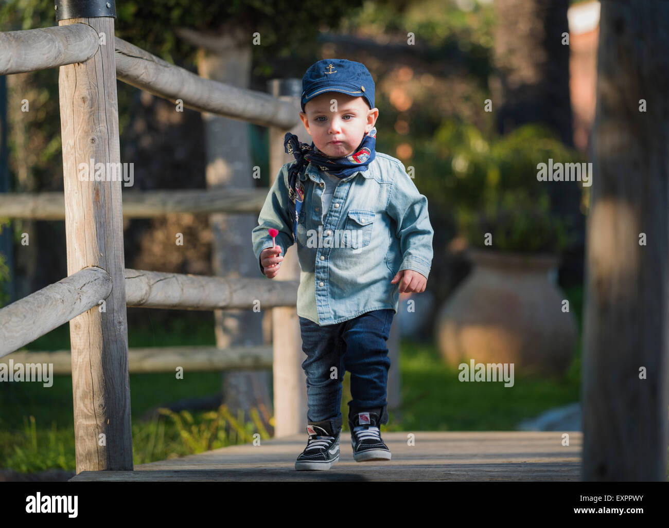 Young child walking across a wooden bridge Stock Photo - Alamy