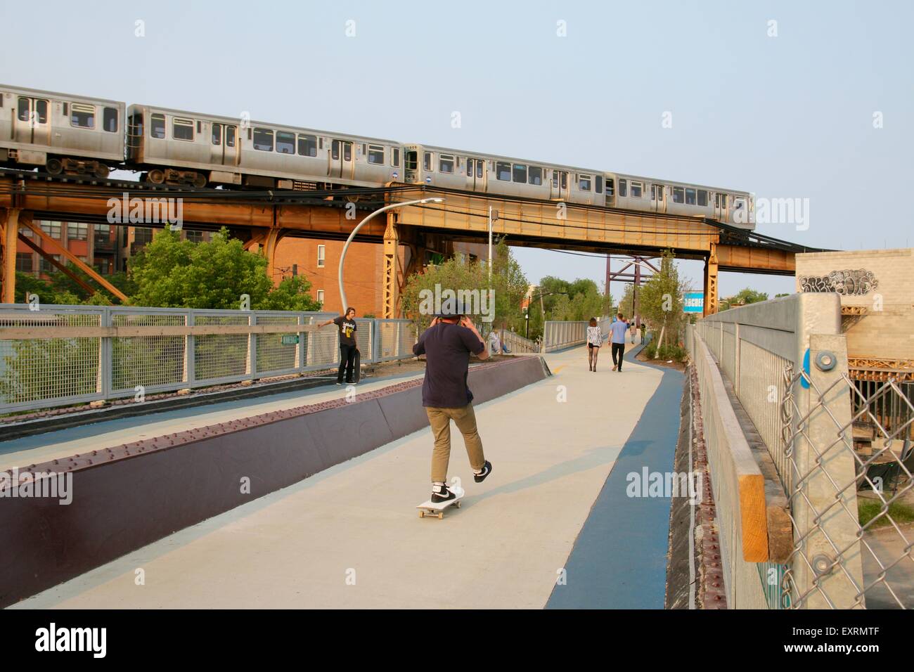 Skateboarder on 606/Bloomingdale Trail, CTA Blue Line bridge. Chicago ...