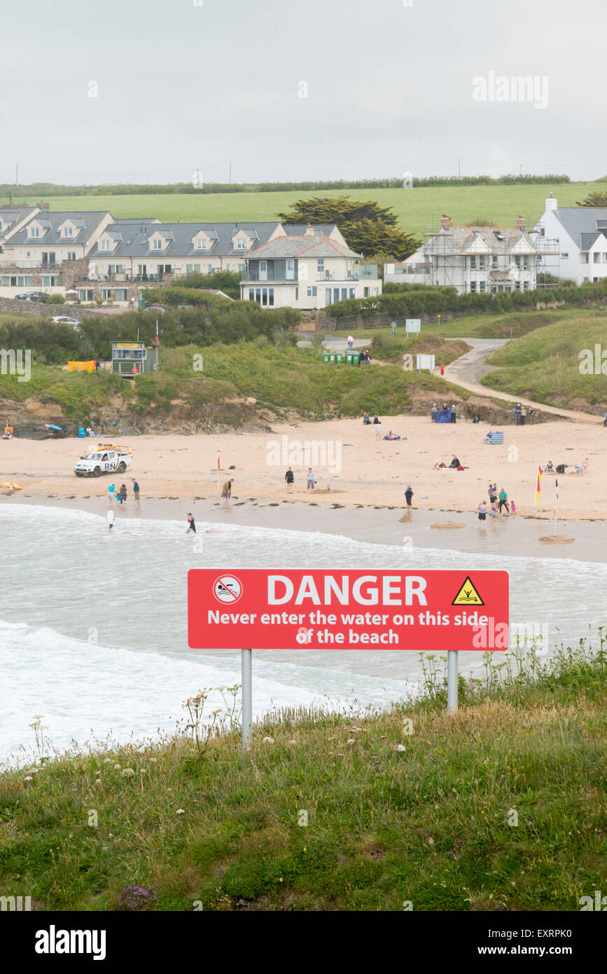 A Danger warning sign warning bathers not to enter the sea on one side ...