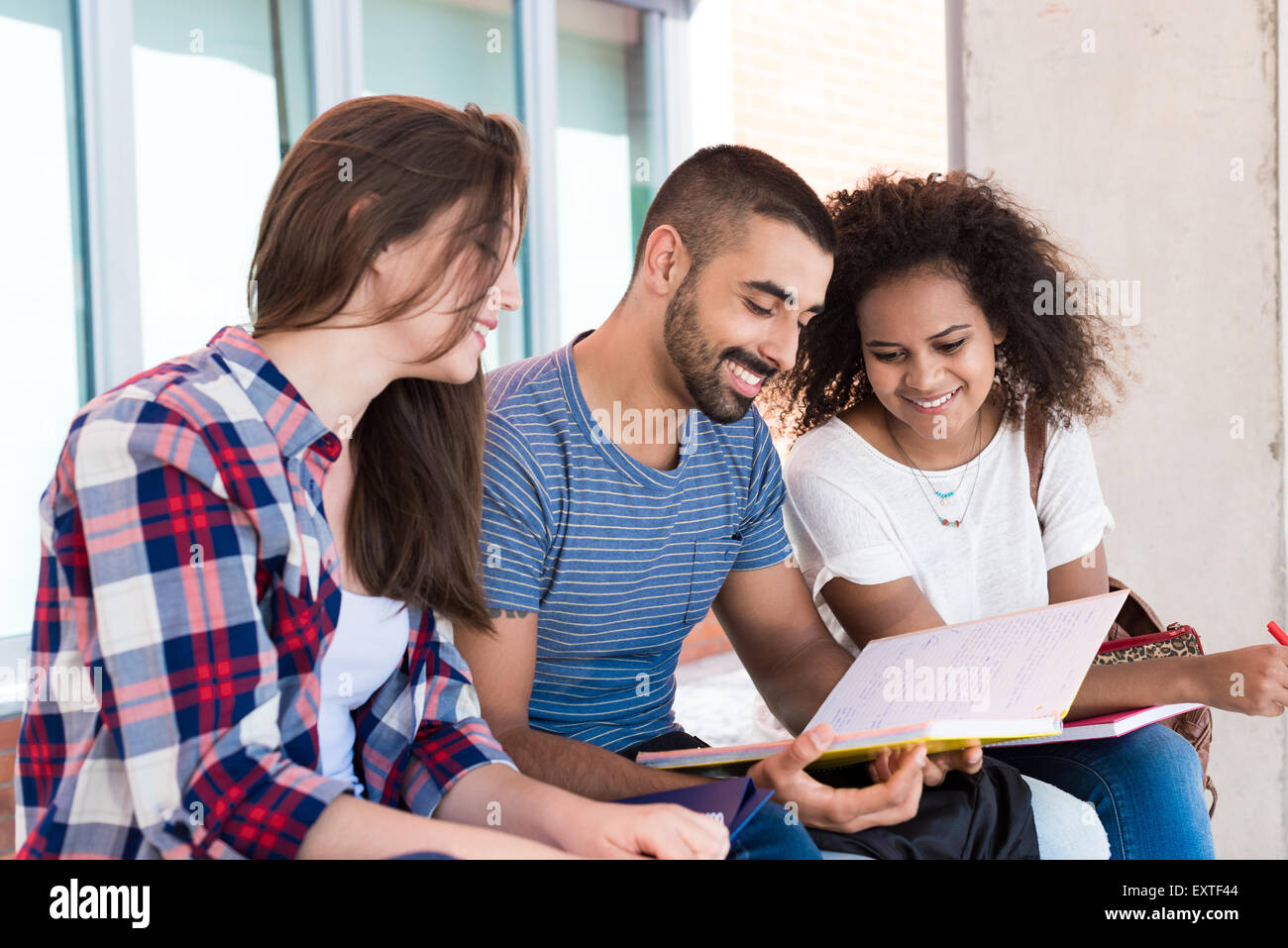 Students sharing notes in the university campus Stock Photo - Alamy