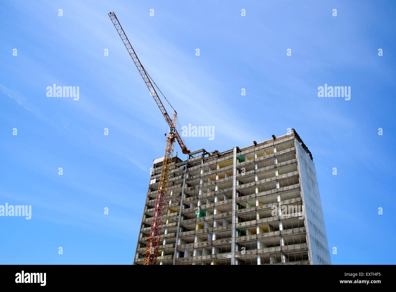 photo showing the demolition of a skyscraper with a high crane Stock ...