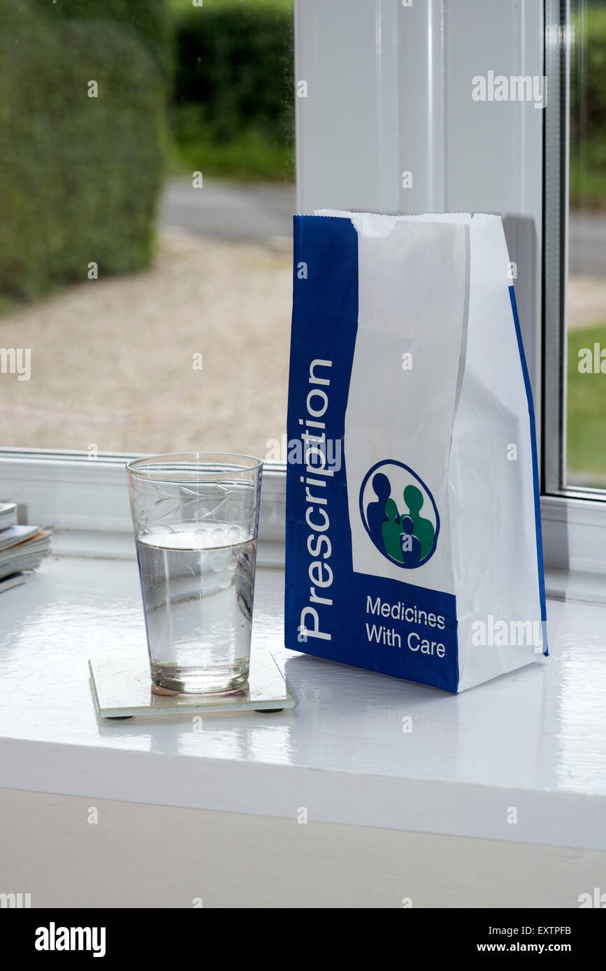 Glass of water and a packet of prescription drugs Stock Photo - Alamy