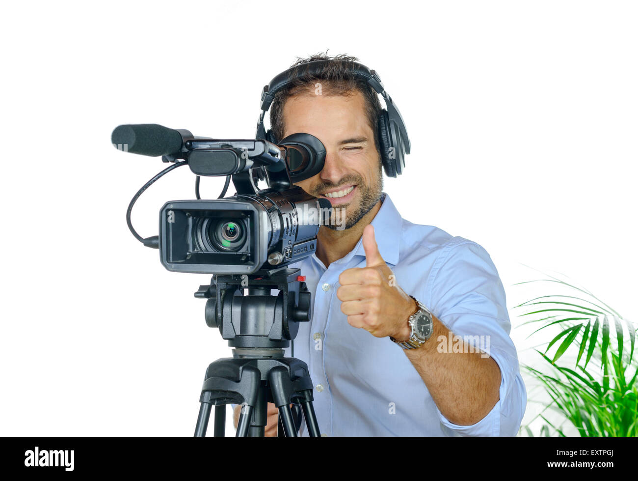 Young man with professional movie camera on white background Stock ...