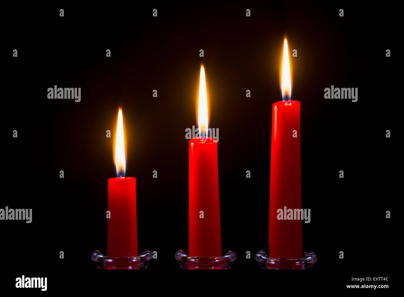 Three red candles on a black background Stock Photo - Alamy