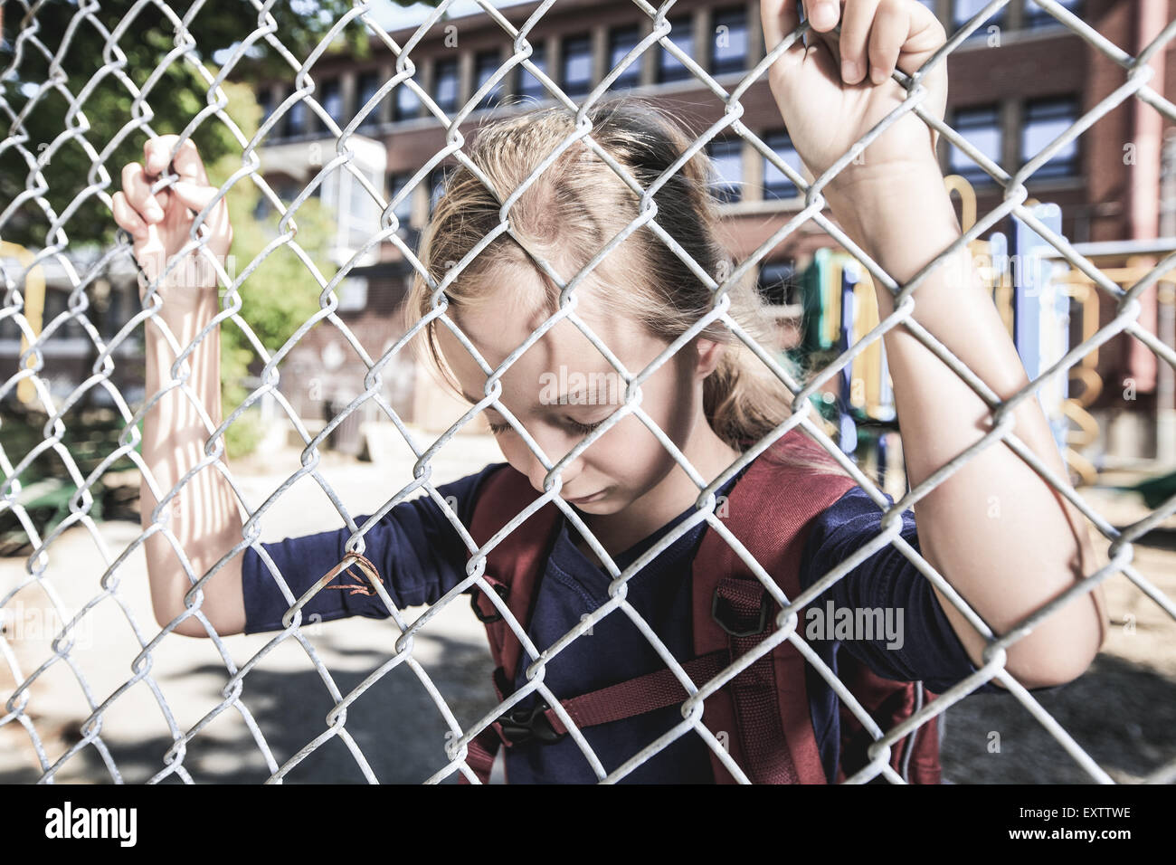 Sad fence girl Stock Photo - Alamy