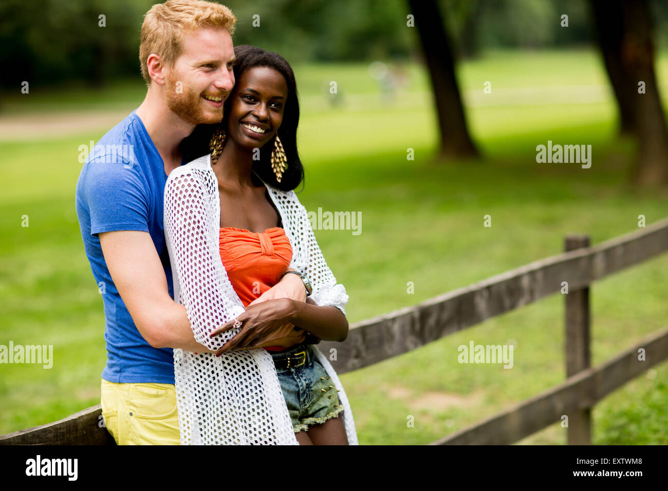 Multiracial couple in the park Stock Photo - Alamy