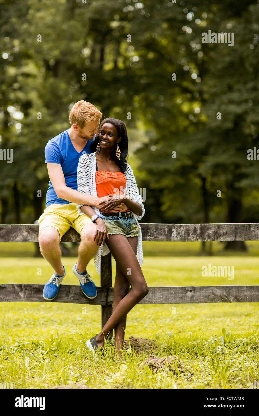 Multiracial couple in the park Stock Photo - Alamy