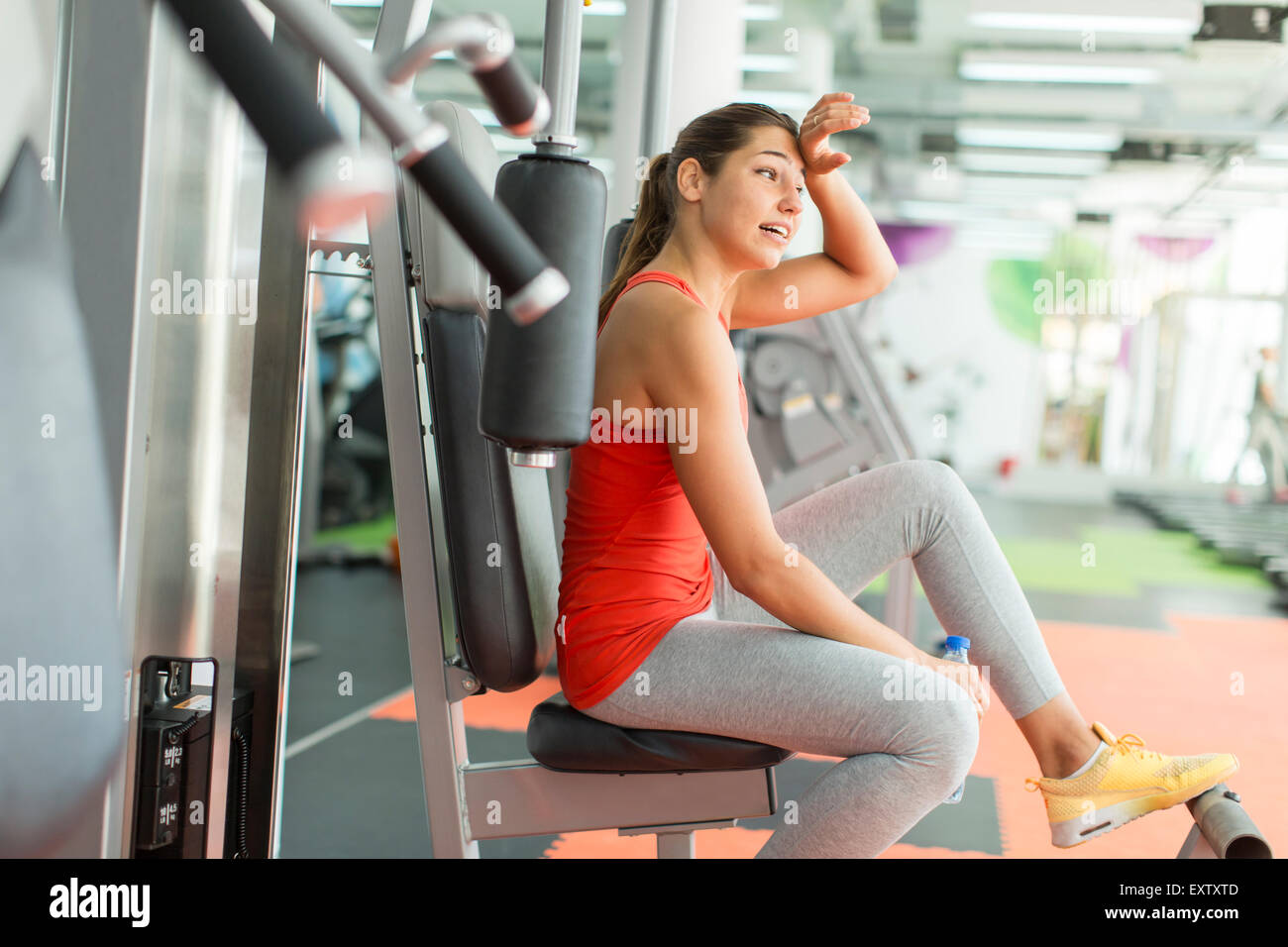 Woman relaxing gym sitting hi-res stock photography and images - Alamy