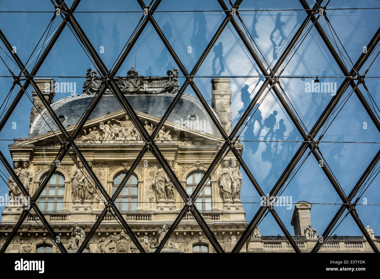 People reflections on Louvre museum pyramid window panes, front ...