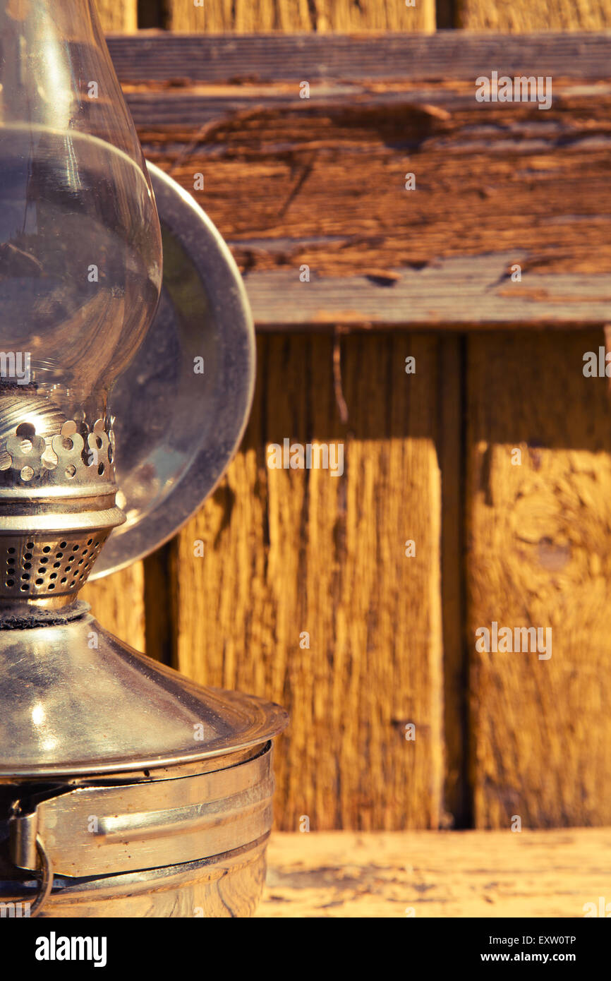 old kerosene lamp stands on wooden surface, outdoors Stock Photo - Alamy