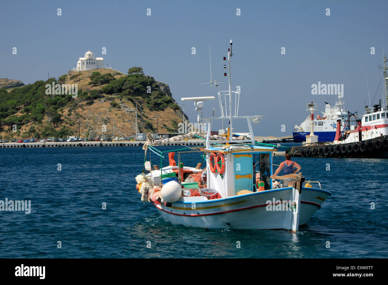 Lemnian fishermen going fishing with their traditional wooden boat ...