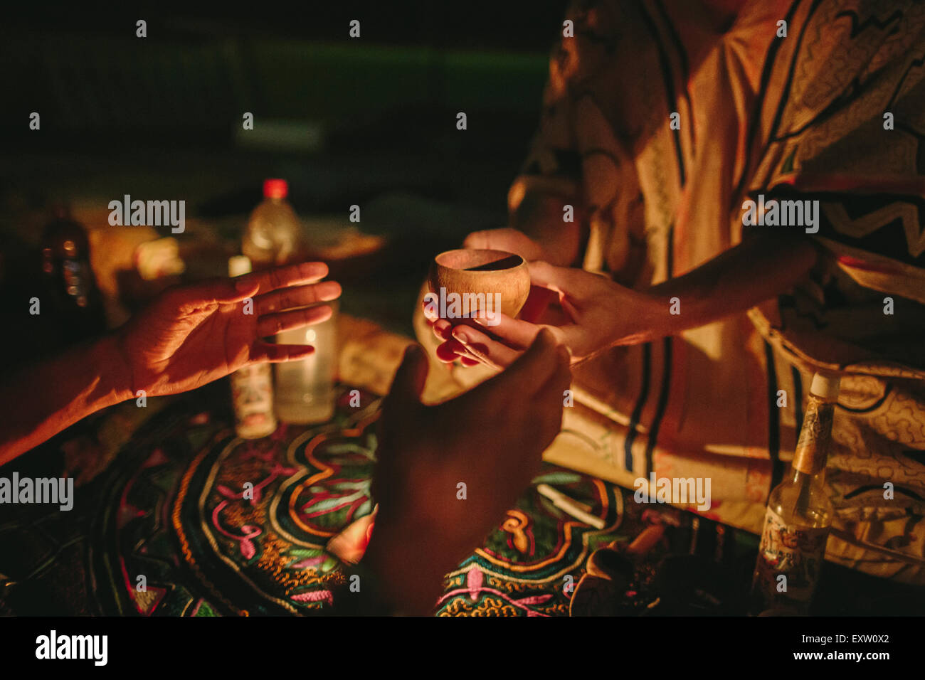 A man receives a cup of Ayahuasca, a traditional Amazonian plant ...