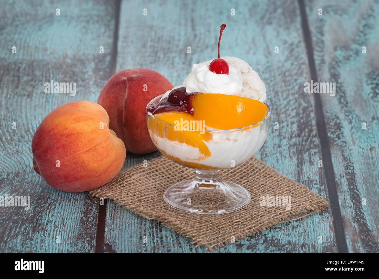 Vanilla peach melba ice cream with peach fruits on wooden vintage ...