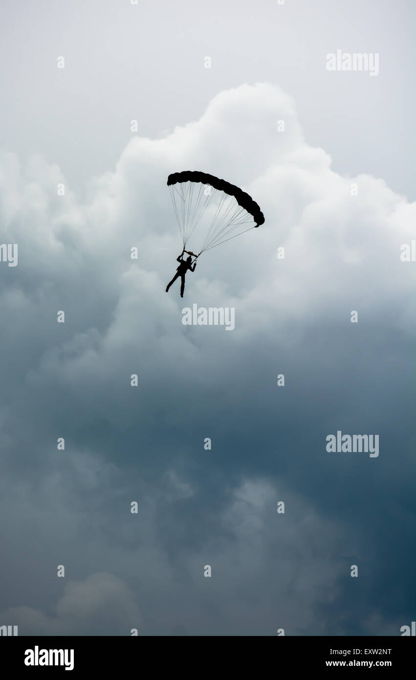 Parachute Flying High In The Clouds Stock Photo - Alamy