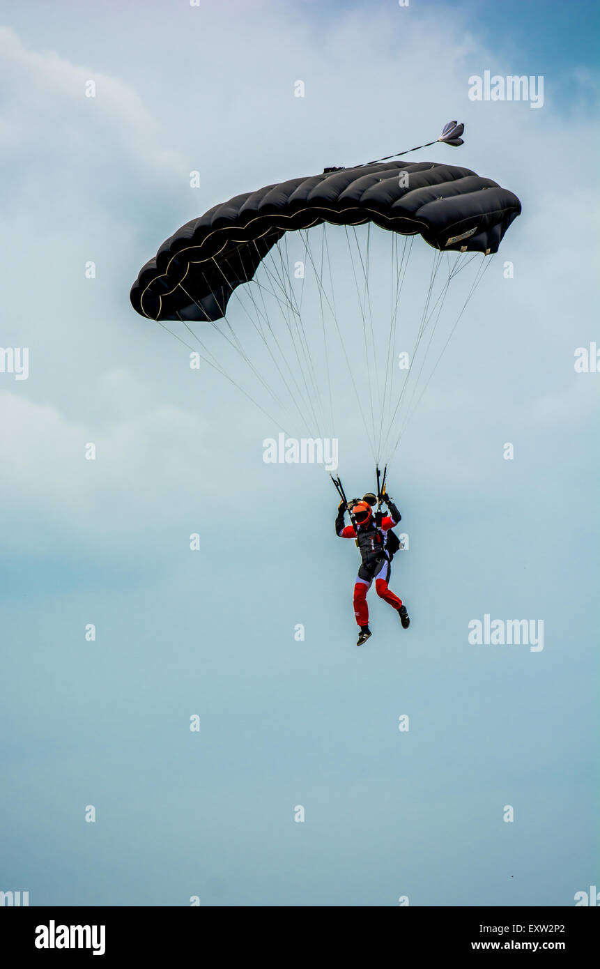 Parachute Flying High In The Clouds Stock Photo - Alamy